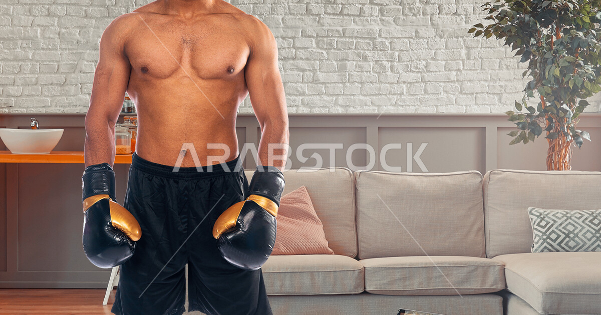 A young Arab Gulf, a Saudi Gulf, wearing boxing costume and boxing ...