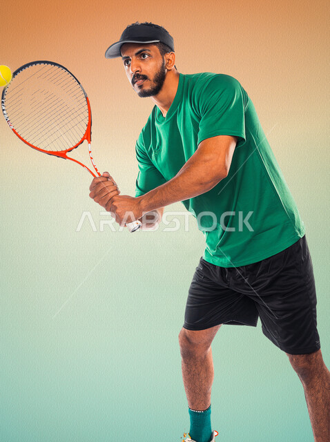 A young Arab Gulf Gulf in the sports stadium, holding a tennis racket ...