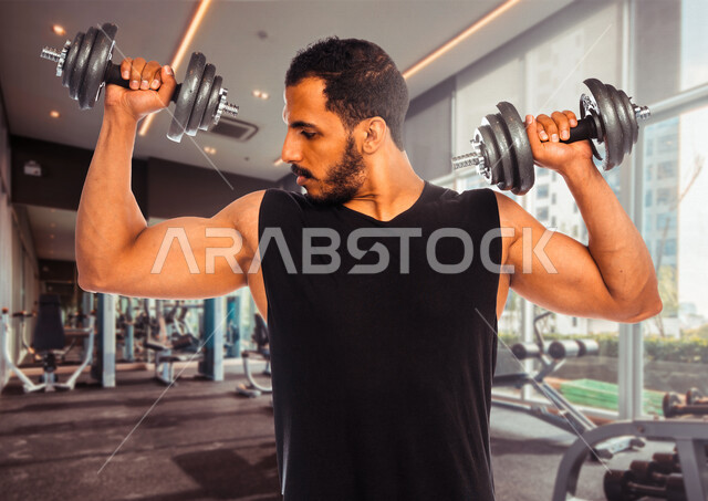 A young Arab Gulf Gulf in the sports club, wearing sportswear ...