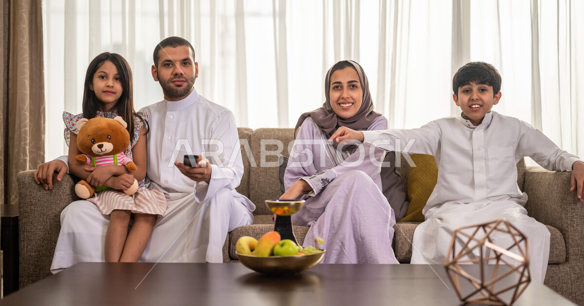 A Saudi Arabian Gulf family sitting in the living room, family ...