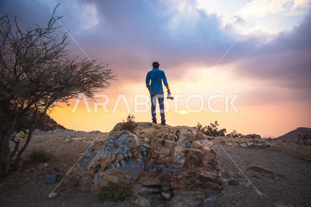 A picture of a tourist spending fun times over the mountains of the ...
