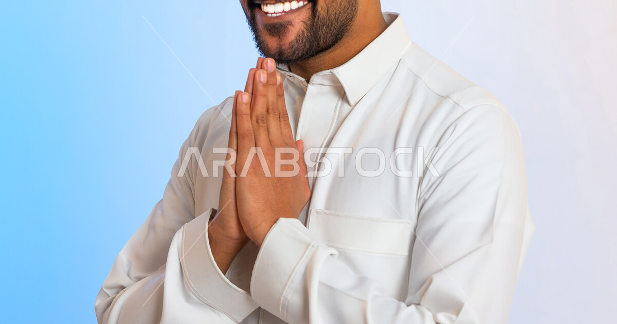 Portrait of a smiling and happy Saudi Arabian Gulf youth with gestures ...