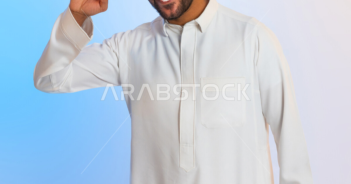 Portrait of a smiling and happy Saudi Arabian Gulf youth with gestures ...