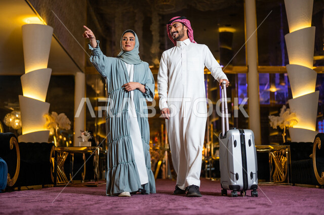 A Saudi Arabian Gulf couple, smiling tourists, walking together on a ...