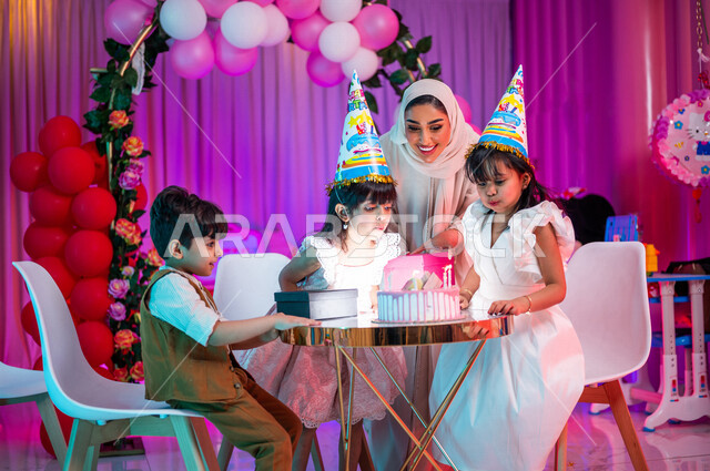 A Saudi Arabian Gulf woman celebrates the birthday of her two daughters ...
