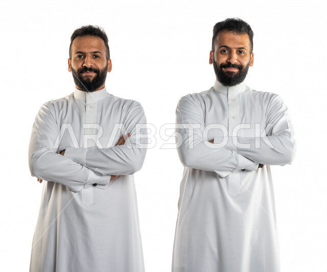 Portrait of two smiling and happy Saudi Arabian Gulf Arab twin men ...