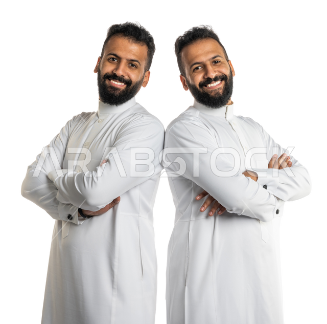 Portrait of two smiling and happy Saudi Arabian Gulf Arab twin men ...