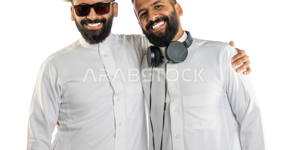 Portrait of two smiling and happy Saudi Arabian Gulf Arab twins, one ...