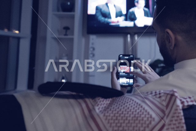 A view from the back of a young Saudi Arabian Gulf youth showing the ...