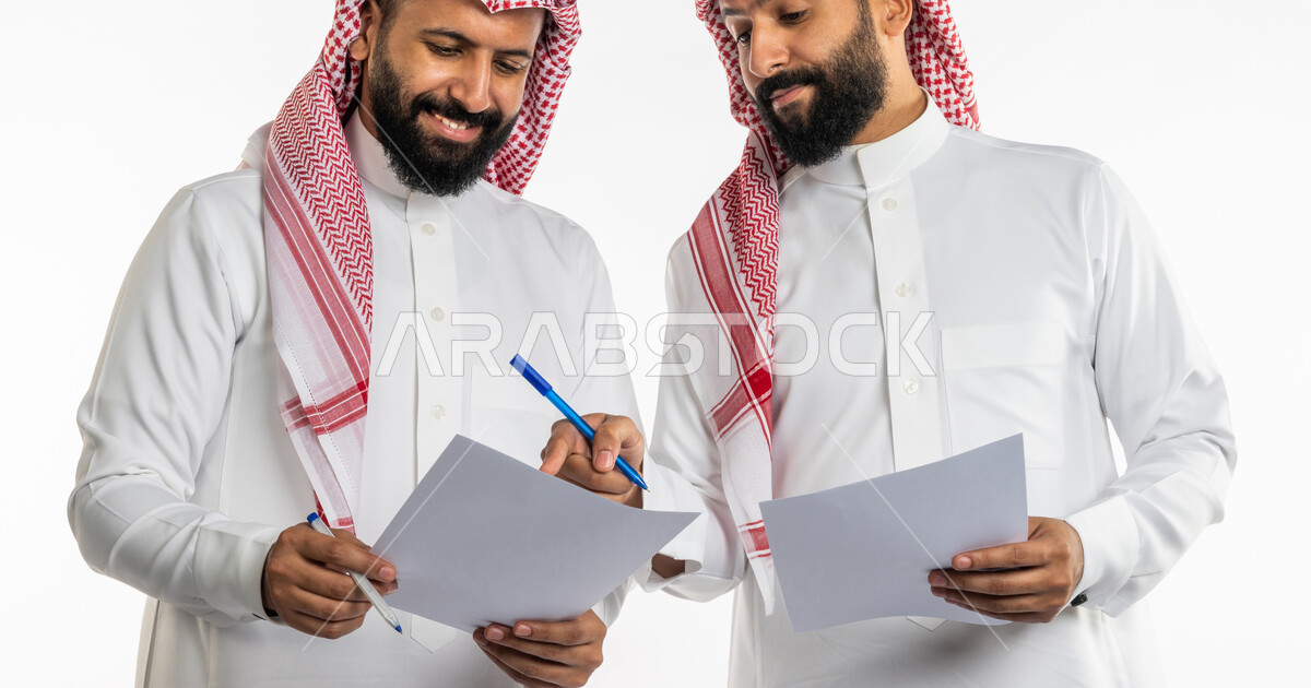 Portrait of two Saudi Arabian Gulf twin men, work discussion, co ...