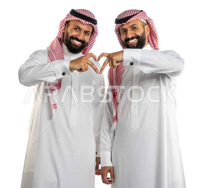 Portrait of two smiling and happy Saudi Arabian Gulf Arab twin men ...