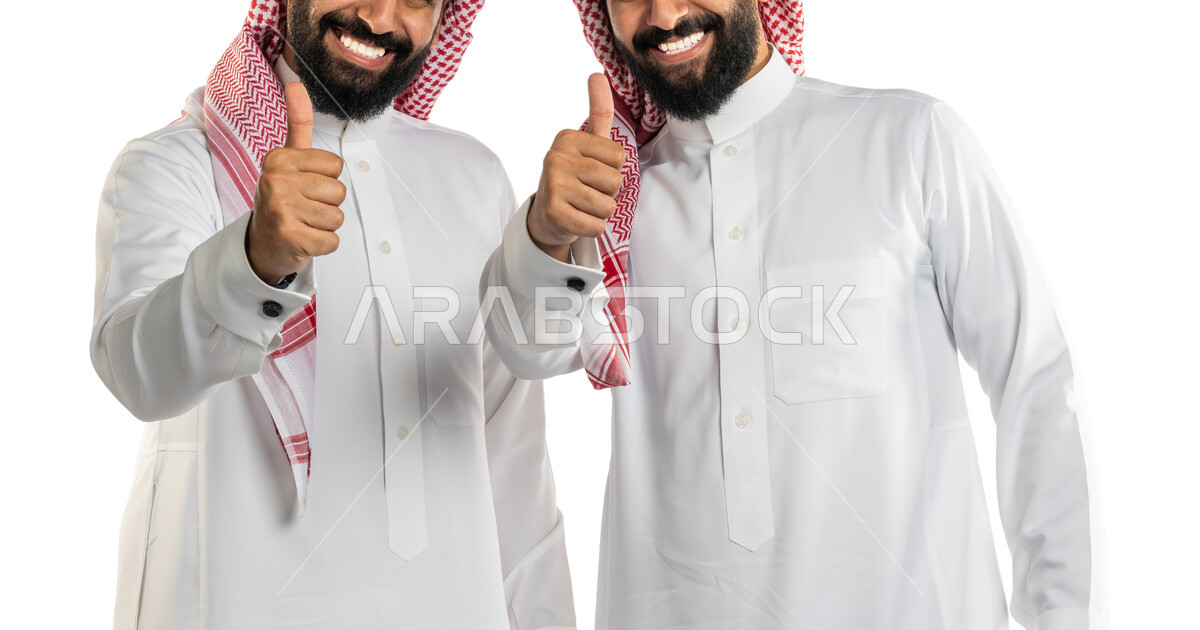 Portrait of two Saudi Arabian Gulf twin men, thumbs up, approval and ...