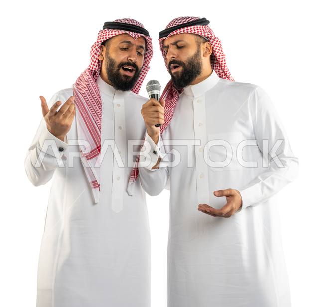 Portrait of two Saudi Arabian Gulf twin men enjoying singing, singing ...