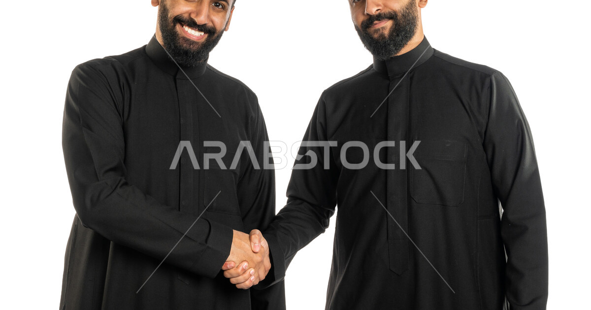 Portrait of two Saudi Arabian Gulf twin men, interconnected brotherly ...