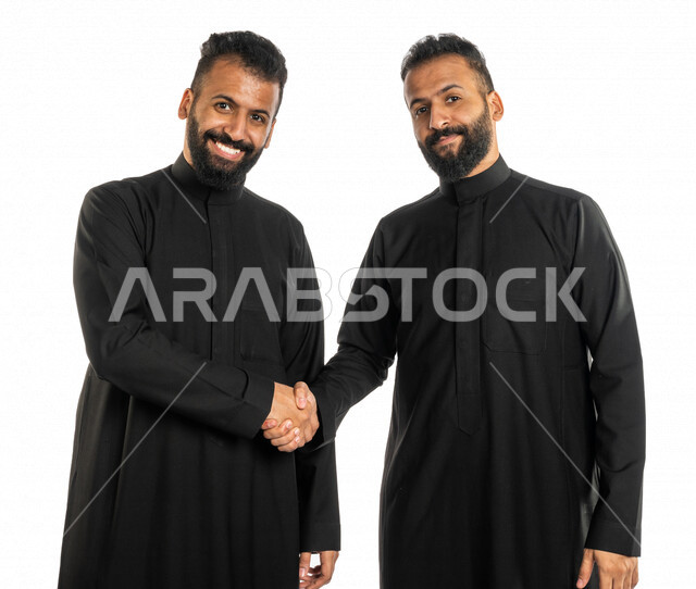 Portrait of two Saudi Arabian Gulf twin men, interconnected brotherly ...