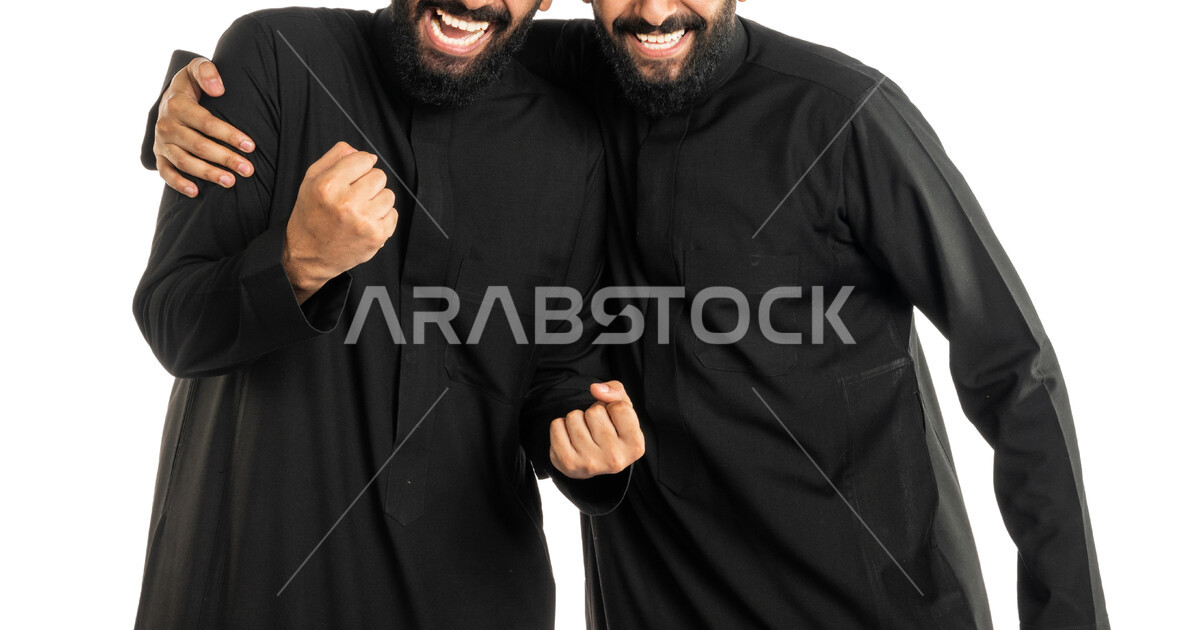 Portrait of two Saudi Arabian Gulf twin men, joy of victory and victory ...