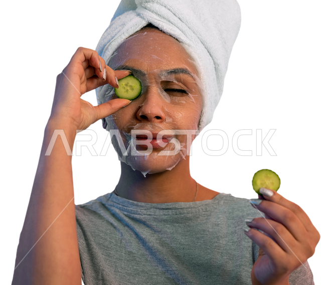 Portrait of a Saudi Arabian Gulf woman, putting the cosmetic mask on ...