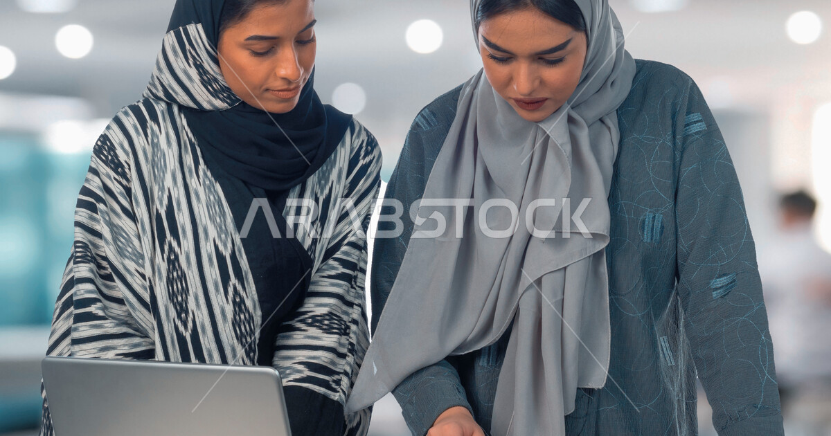 Two Saudi Arabian Gulf women in the work office, work meeting, task ...