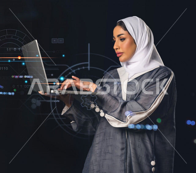 A Saudi Arabian Gulf woman working as a web developer, using a computer ...