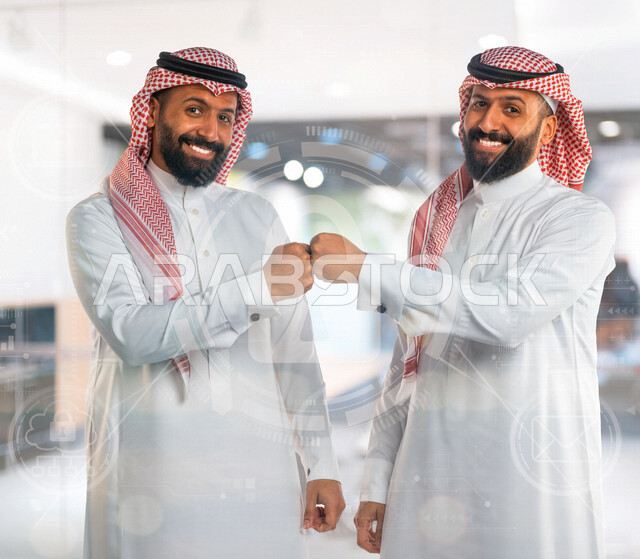 Two Saudi Arabian Gulf twin men at the company’s headquarters, fist ...