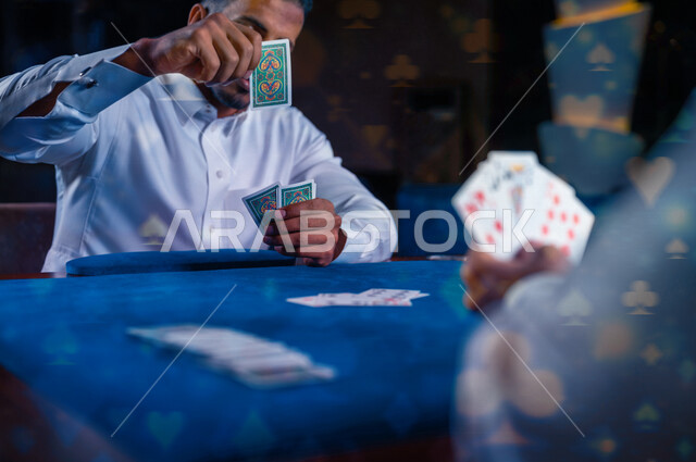 Two Saudi Arabian Gulf youths playing a card game in one of the high ...