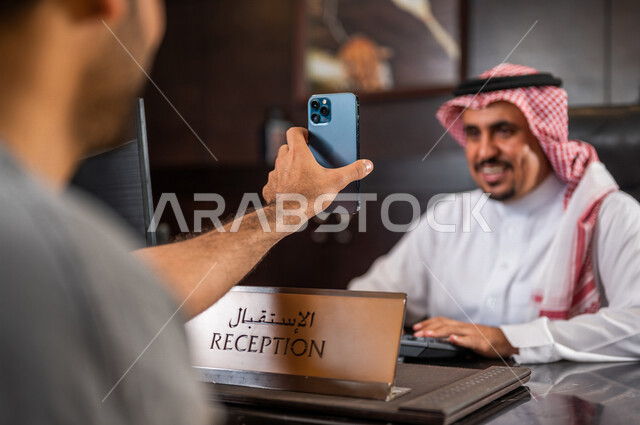 A Saudi Arabian Gulf tourist who displays the mobile phone of a Saudi ...