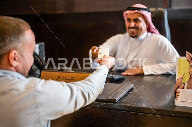 A Saudi Arabian Gulf receptionist who happily delivers the hotel room ...