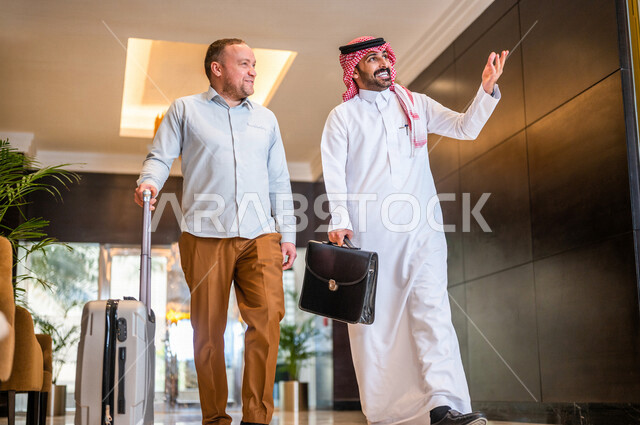 A Saudi Arabian Gulf man accompanied by an Arab tourist wearing casual ...