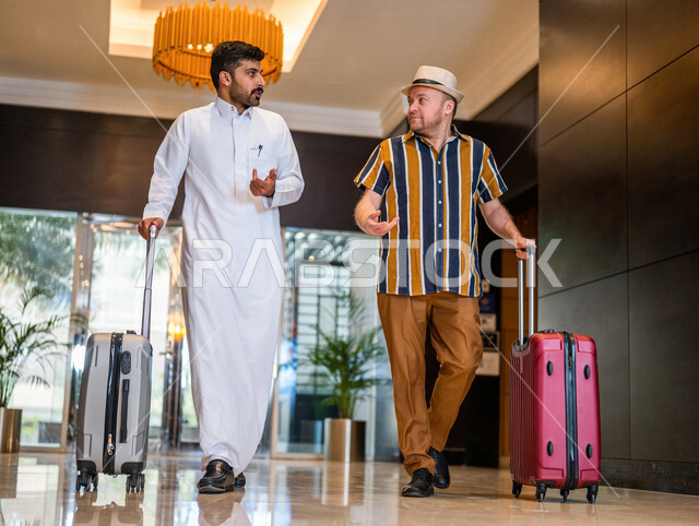 A Saudi Arabian Gulf man accompanied by an Arab tourist wearing casual ...