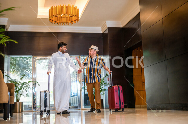 A Saudi Arabian Gulf man accompanied by an Arab tourist wearing casual ...