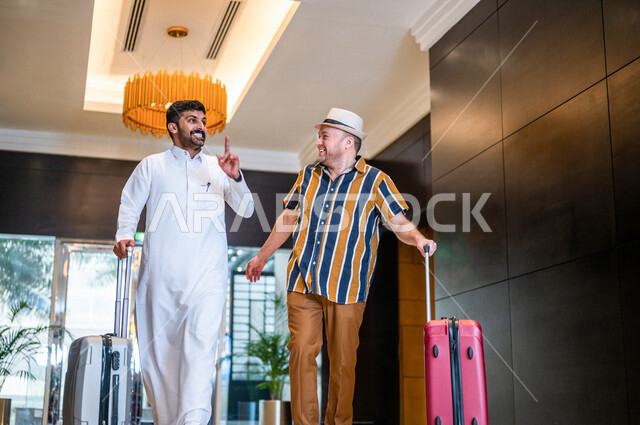 A Saudi Arabian Gulf man accompanied by an Arab tourist wearing casual ...