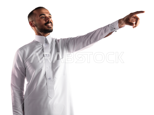 Portrait of a smiling Saudi Arabian Gulf man pointing his index finger ...
