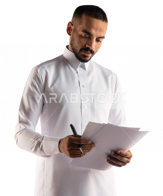 Portrait of a Saudi Arabian Gulf man holding a pen and a set of papers ...
