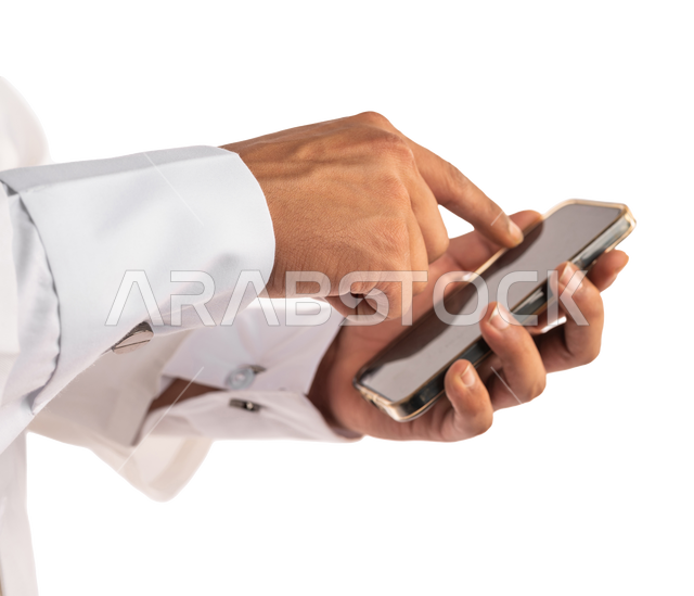 A close-up of the hand of a Saudi Arabian Gulf youth making a phone ...