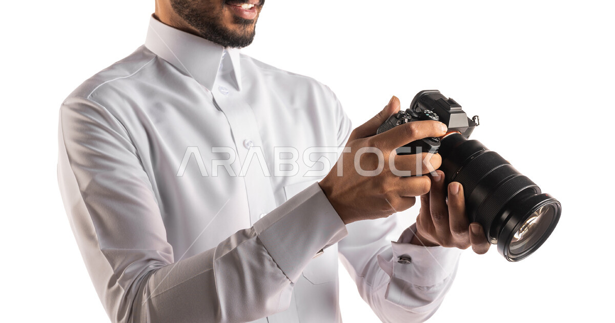 Portrait of a Saudi Arabian Gulf youth holding a high-resolution camera ...