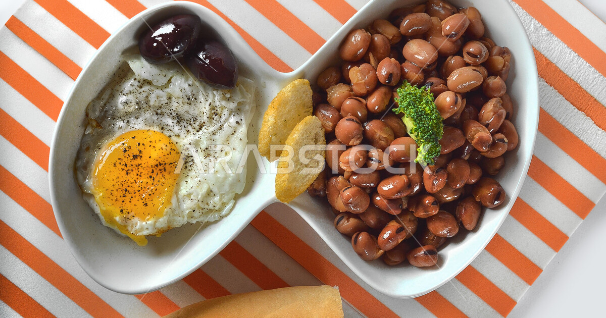 A plate of delicious love beans and fried eggs, traditional Arab food ...