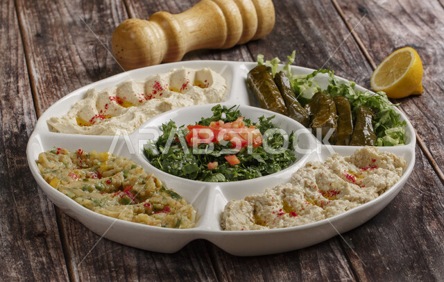 A close-up of a plate of mixed appetizers, Arabic dishes, Arab food ...