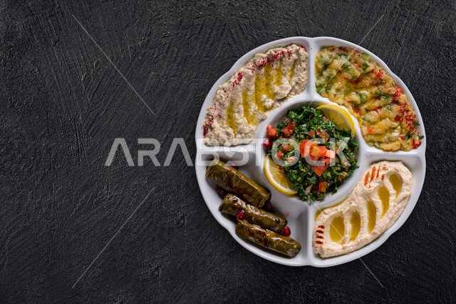 A close-up of a plate of mixed appetizers, Arabic dishes, Arab food ...