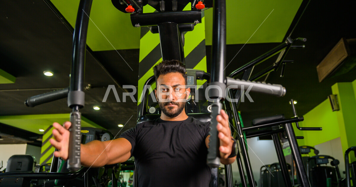 A young Saudi Arabian Gulf man exercising the chest muscle, a Saudi ...