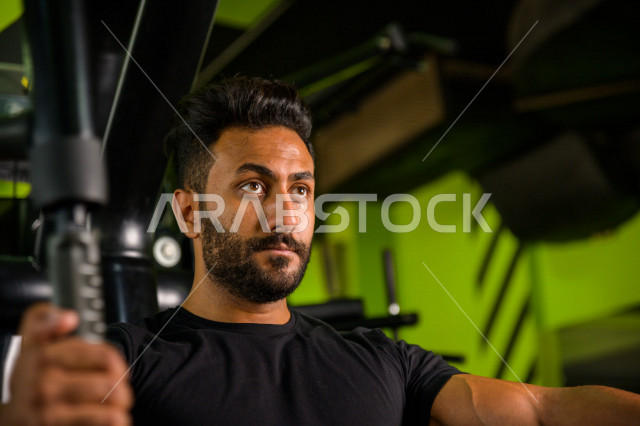 A young Saudi Arabian Gulf man exercising the chest muscle, a Saudi ...