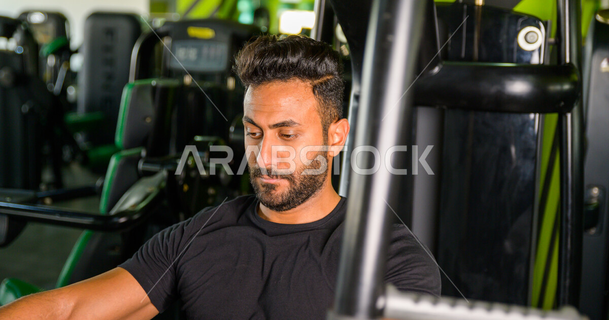 A young Saudi Arabian Gulf man exercising the chest muscle, a Saudi ...