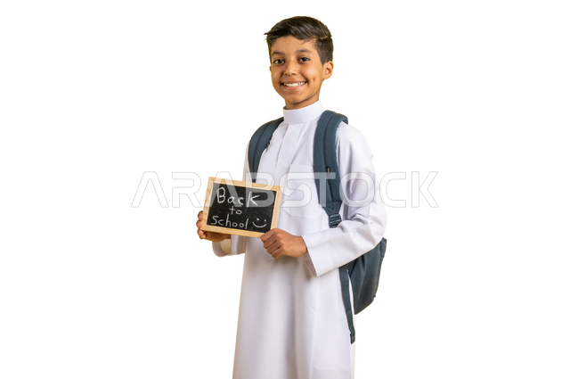 Portrait of a Saudi Arabian Gulf student, carrying a school bag, with a ...