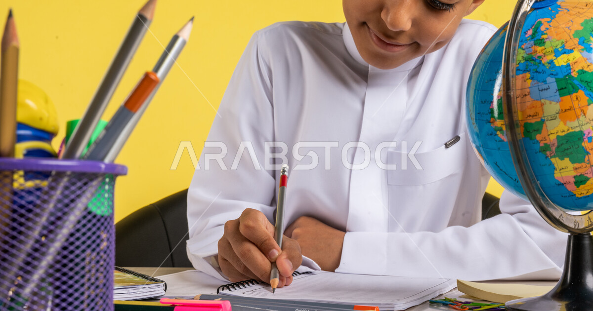 Portrait of a Saudi Arabian Gulf student, in traditional Saudi dress ...