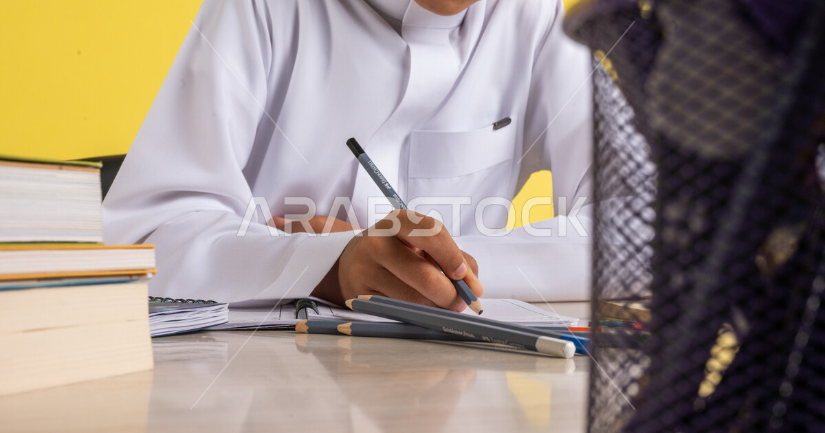 Close-up portrait of a Saudi Arabian Gulf student, wearing traditional ...