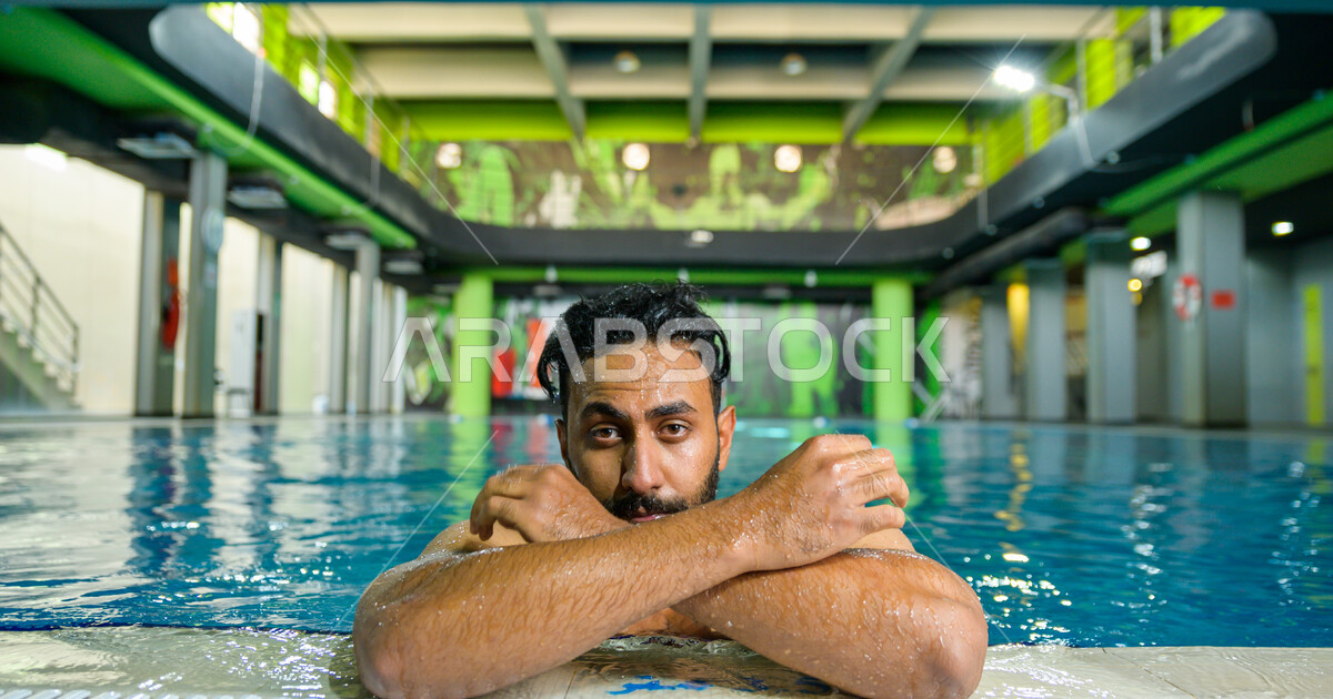 A Saudi Arabian Gulf youth enjoying swimming and practicing swimming in ...