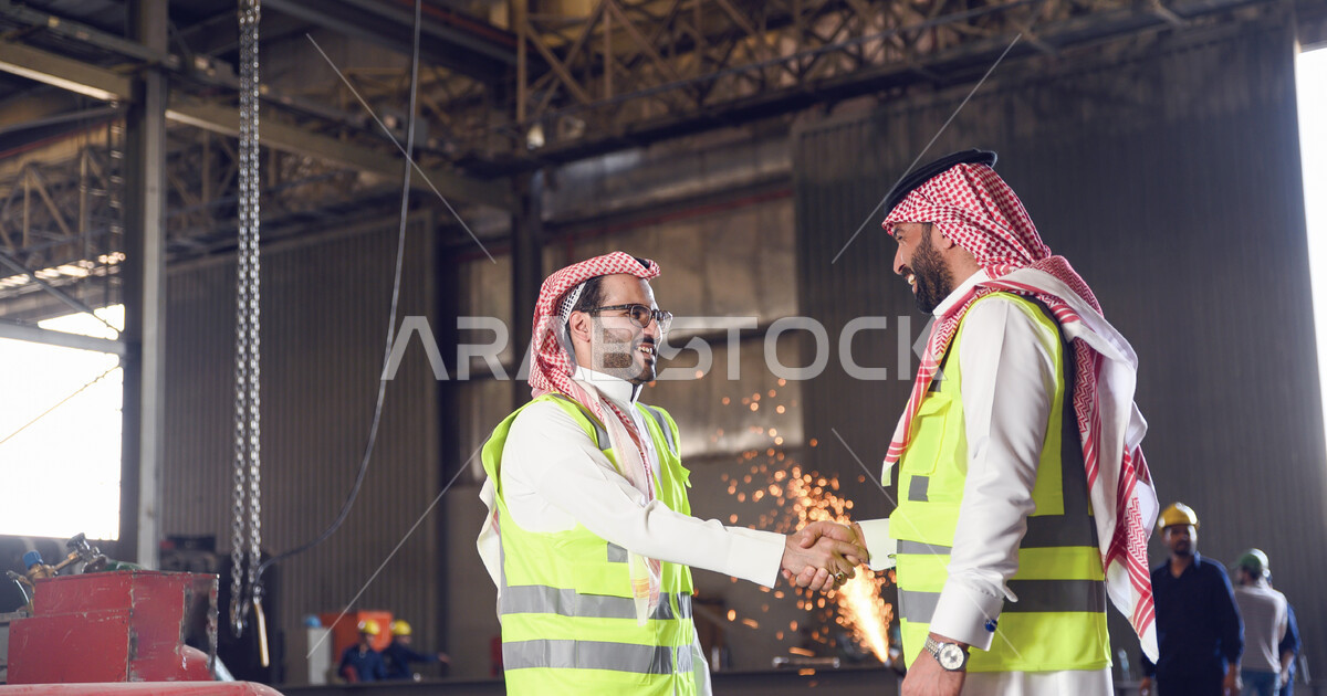 Two Saudi Arabian Gulf industrial engineers wearing safety jackets ...