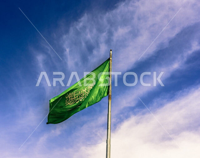 Close-up of Saudi flag pole flying in the sky, Saudi National Day ...
