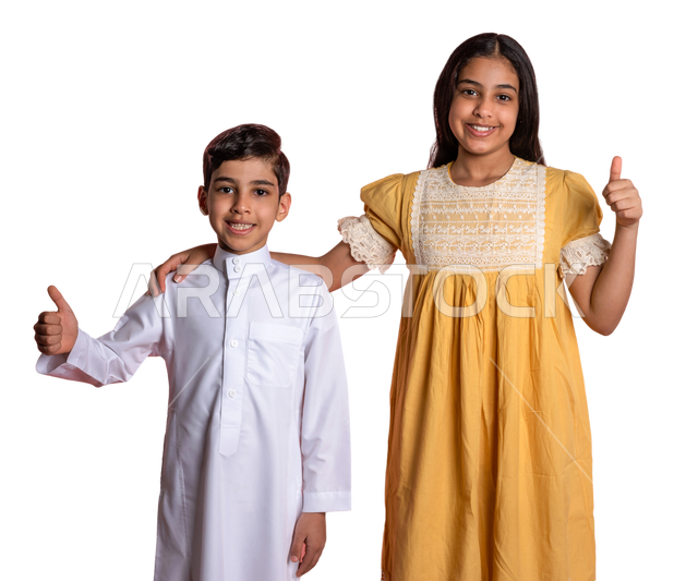 Portrait of two Saudi Arabian Gulf children raising their thumbs up ...