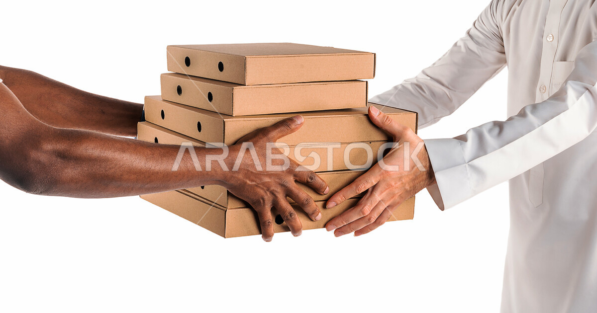 Close-up of the hands of a Saudi Arabian Gulf man carrying cartons for ...
