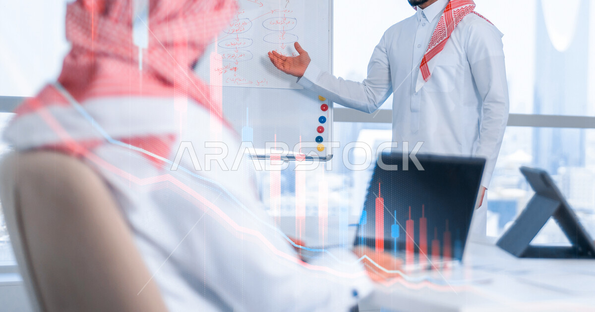 A Saudi Arabian Gulf team in a work meeting inside the company, using ...